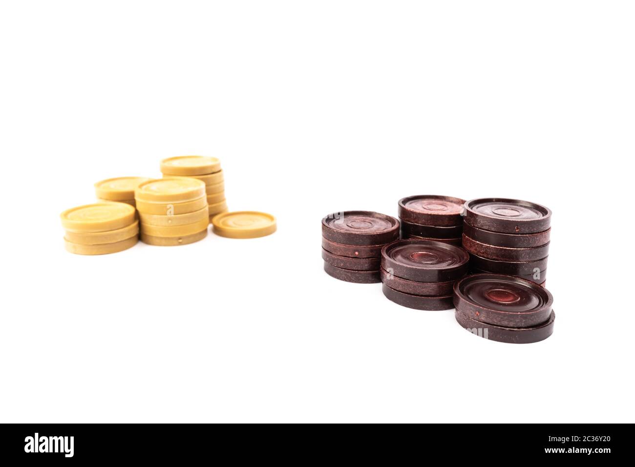 low-end plastic round checkers piece in white background in studio ...