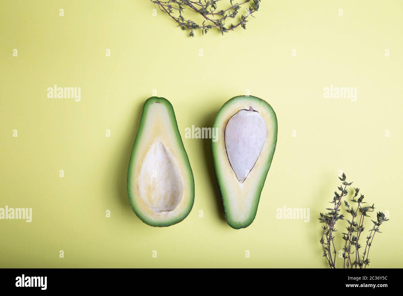 Fresh avocado with herb on yellow background Stock Photo - Alamy
