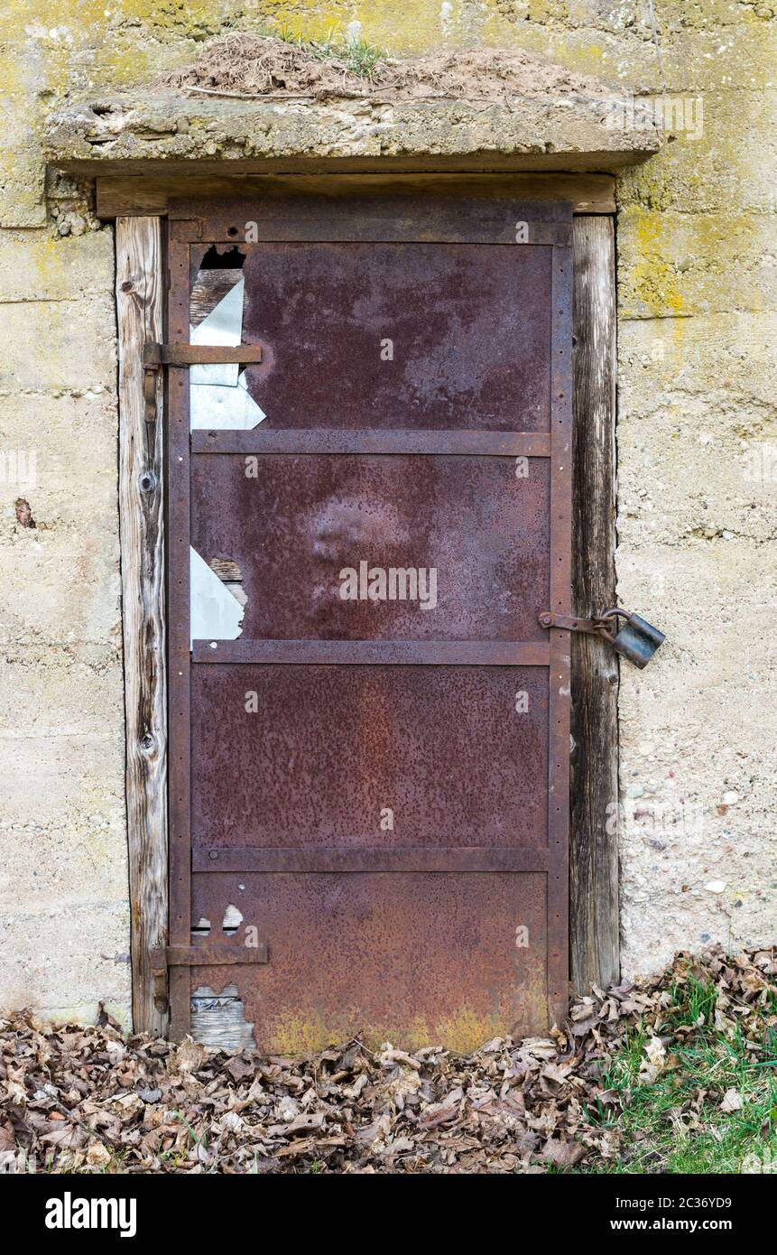 Old rusty metal door into the bunker Stock Photo - Alamy