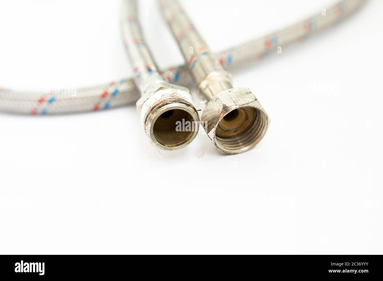 old metal water hose on white background Stock Photo - Alamy