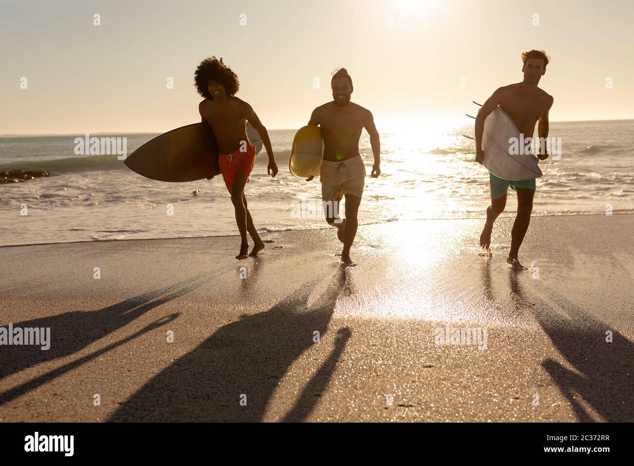 Young men with surf boards hi-res stock photography and images - Alamy