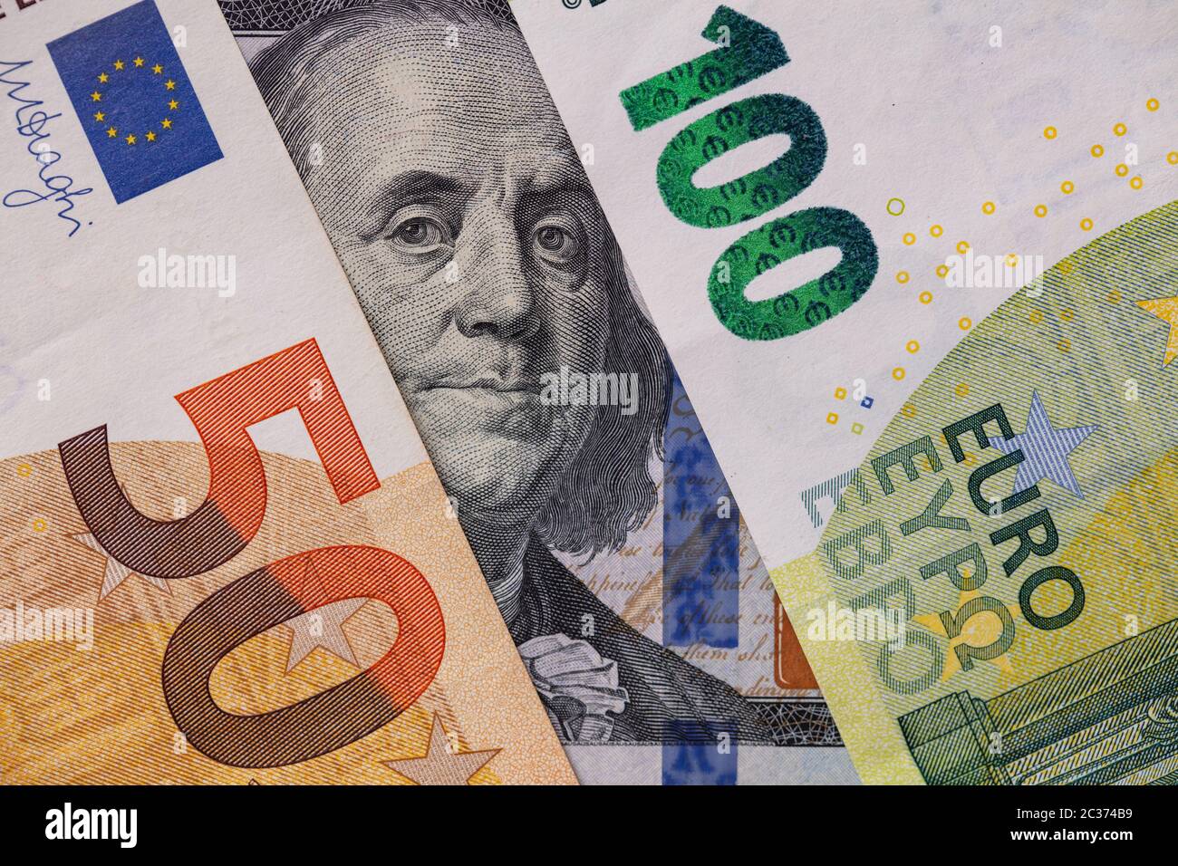 Benjamin Franklin peeking through euro banknotes Stock Photo - Alamy