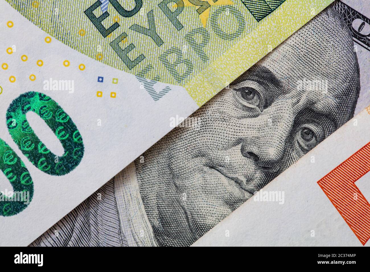 Benjamin Franklin peeking through euro banknotes Stock Photo - Alamy