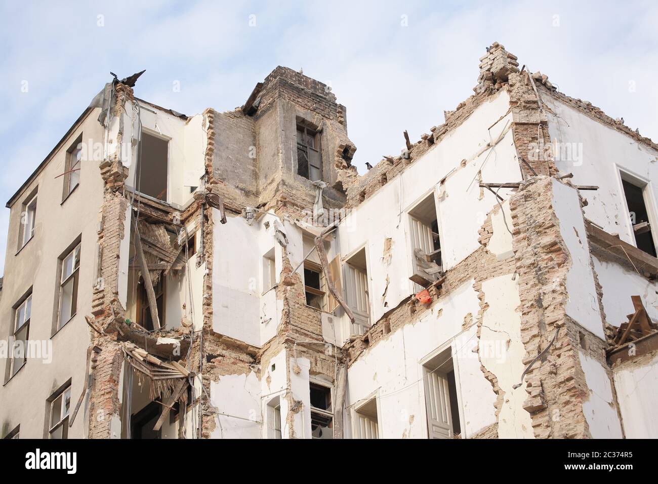 Demolished multistory building with sky, low-angle shot. demolition ...