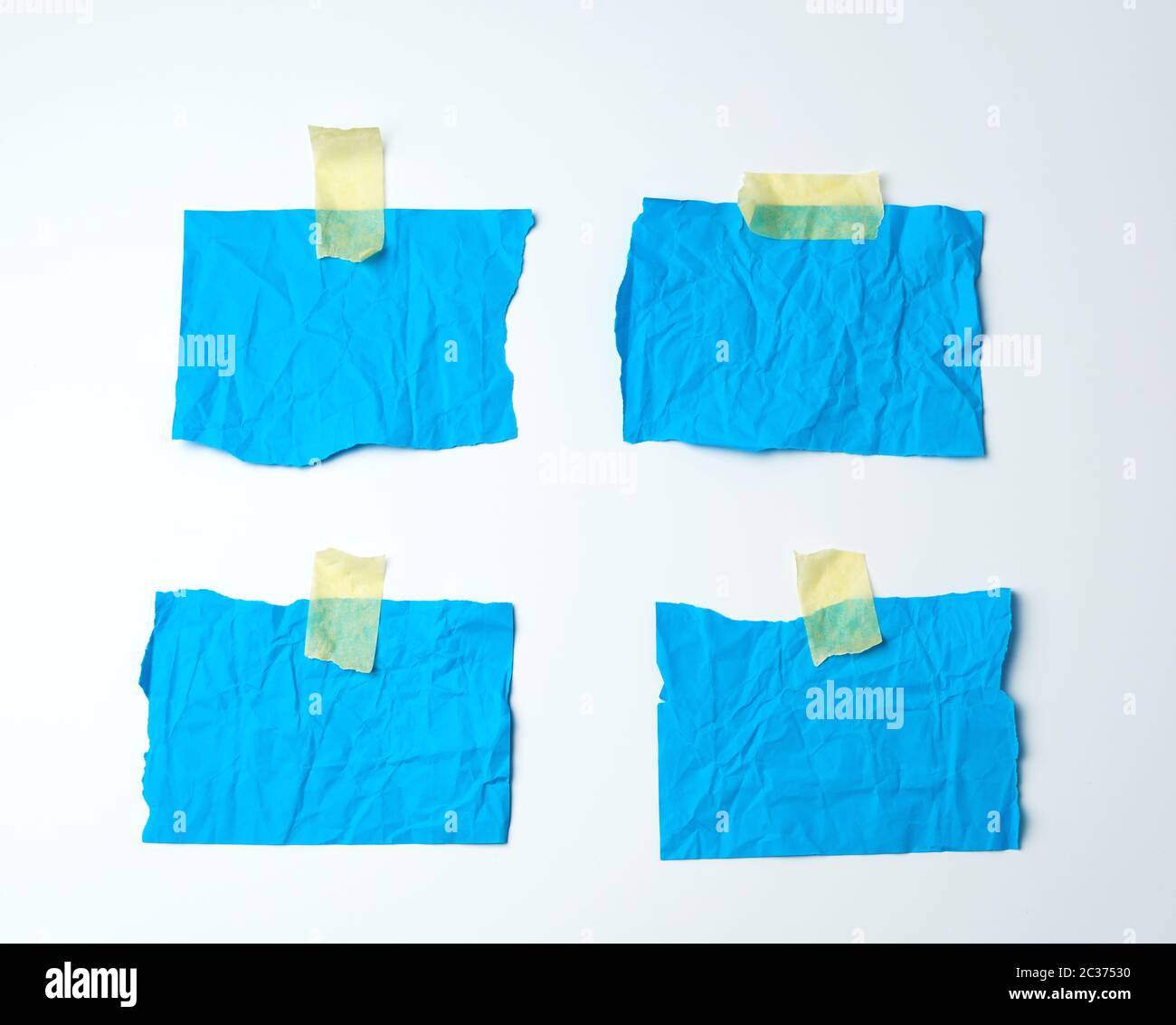empty blue crumpled pieces of paper glued with duct tape on a white ...