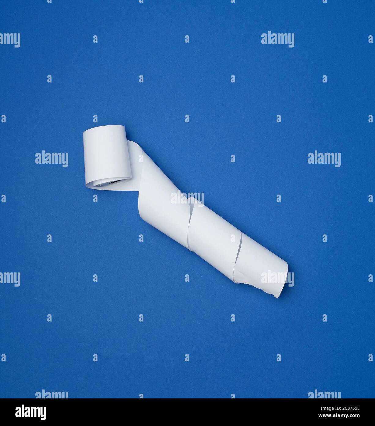 twisted white ribbon for cash register on a blue background, top view ...