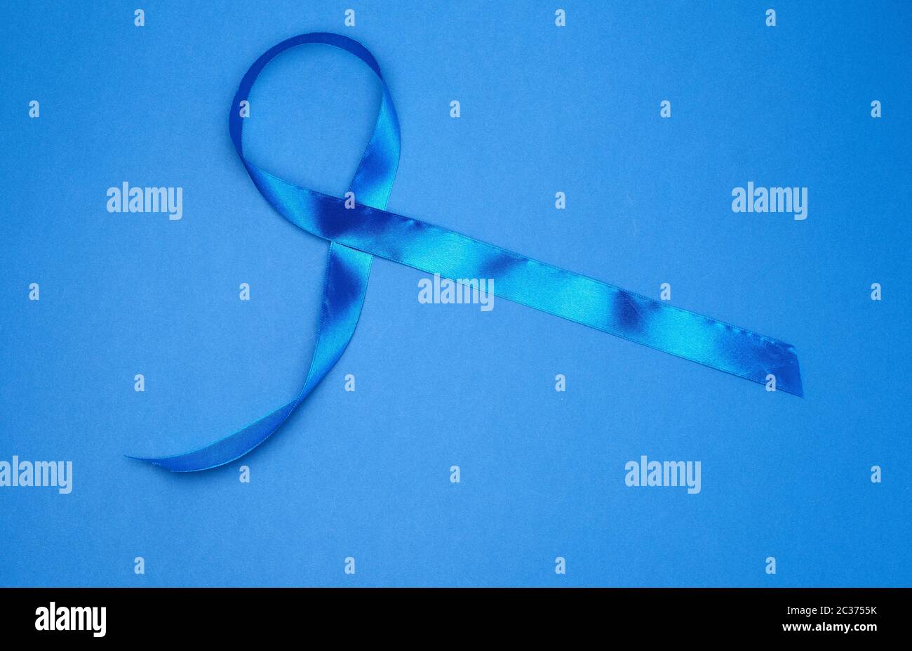 blue silk thin ribbon twisted on a blue background, top view Stock ...