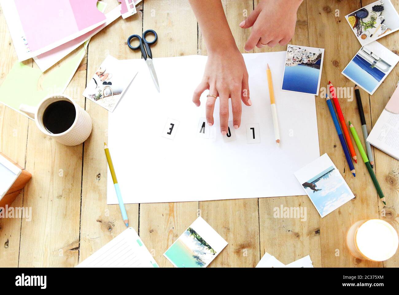 Young brunette woman creating her Feng Shui wish map using scissors ...