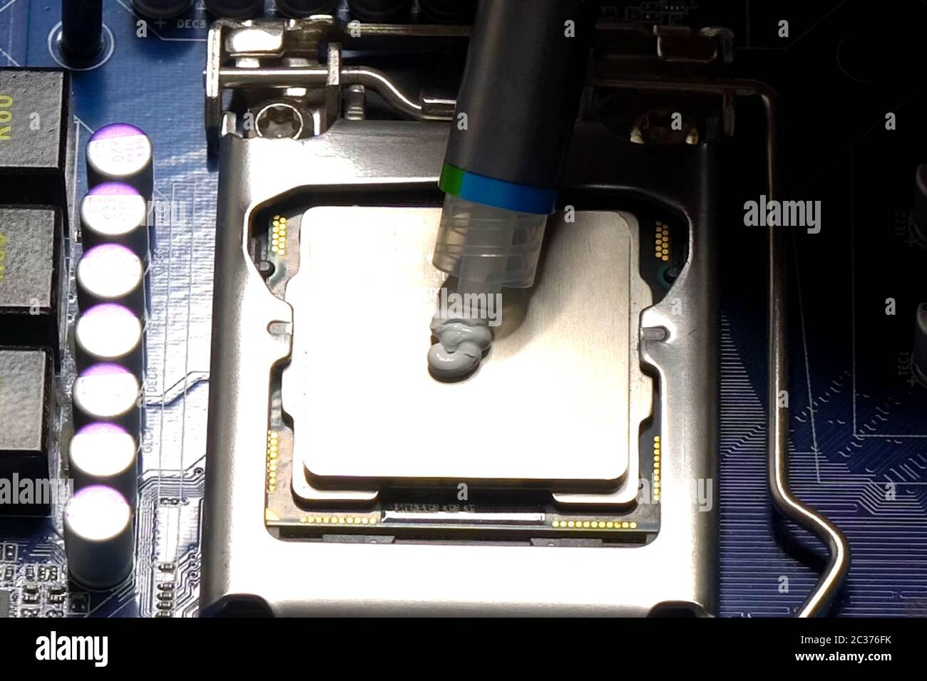 Drawing thermal paste on the computer processor. Installing a cooling system on a CPU processor ...
