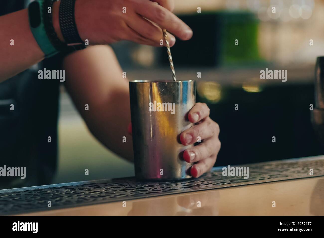 a Bartender pouring cocktail at bar counter Stock Photo - Alamy