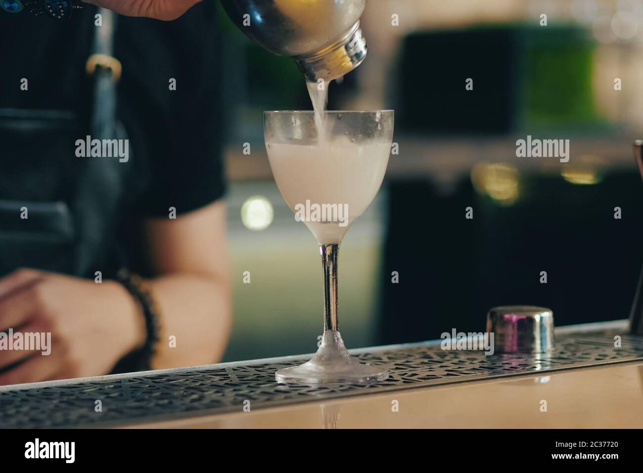 a Bartender pouring cocktail at bar counter Stock Photo - Alamy