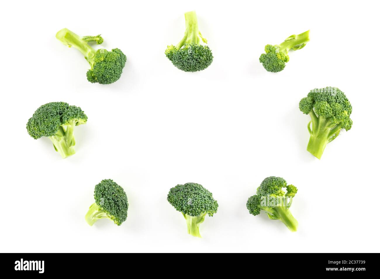 Broccoli florets, shot from the top on a white background, forming a ...
