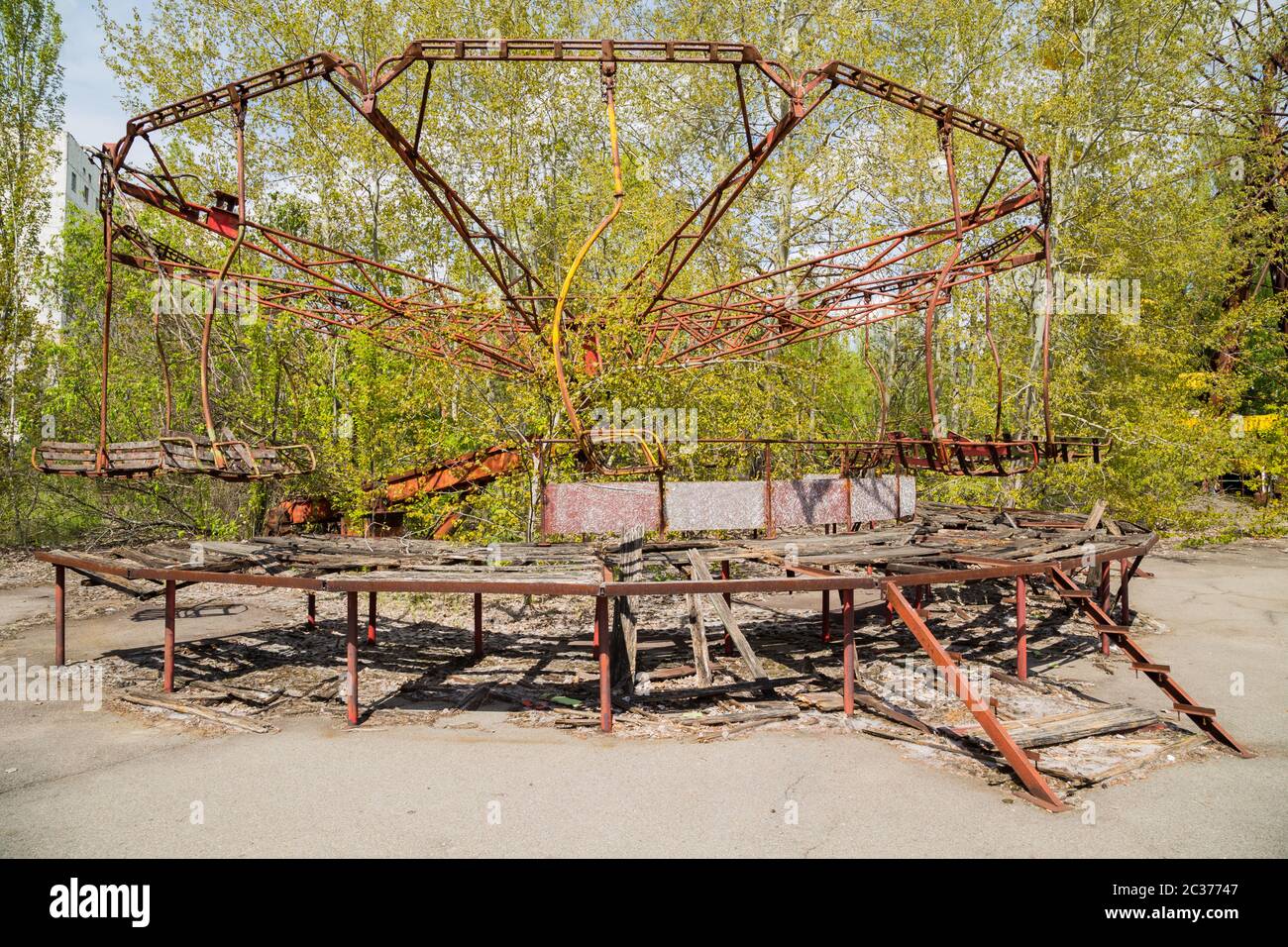 Old broken rusty metal radioactive children's electric wheel abandoned ...