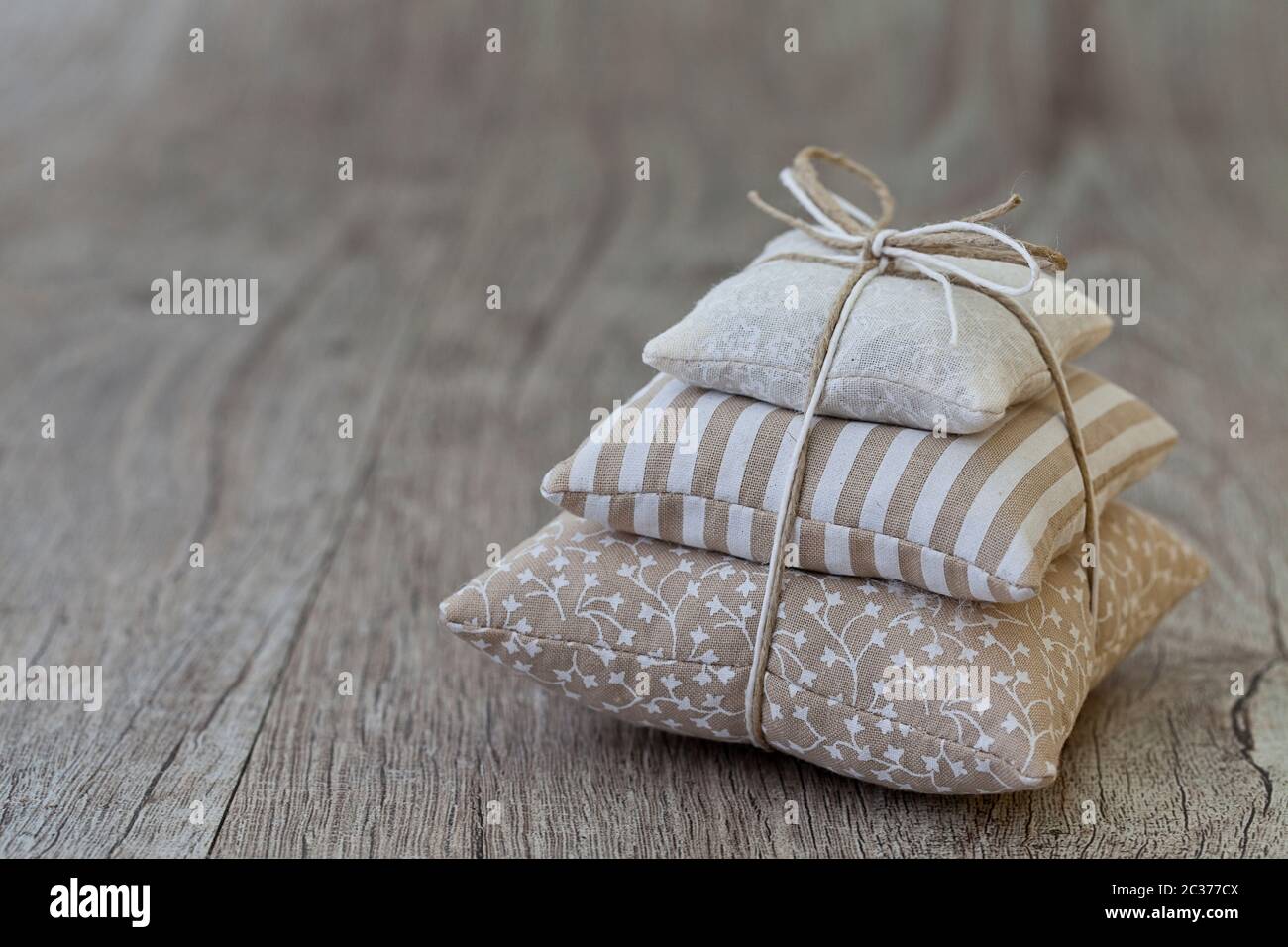 vintage style still life with little decorative pillows tied together ...
