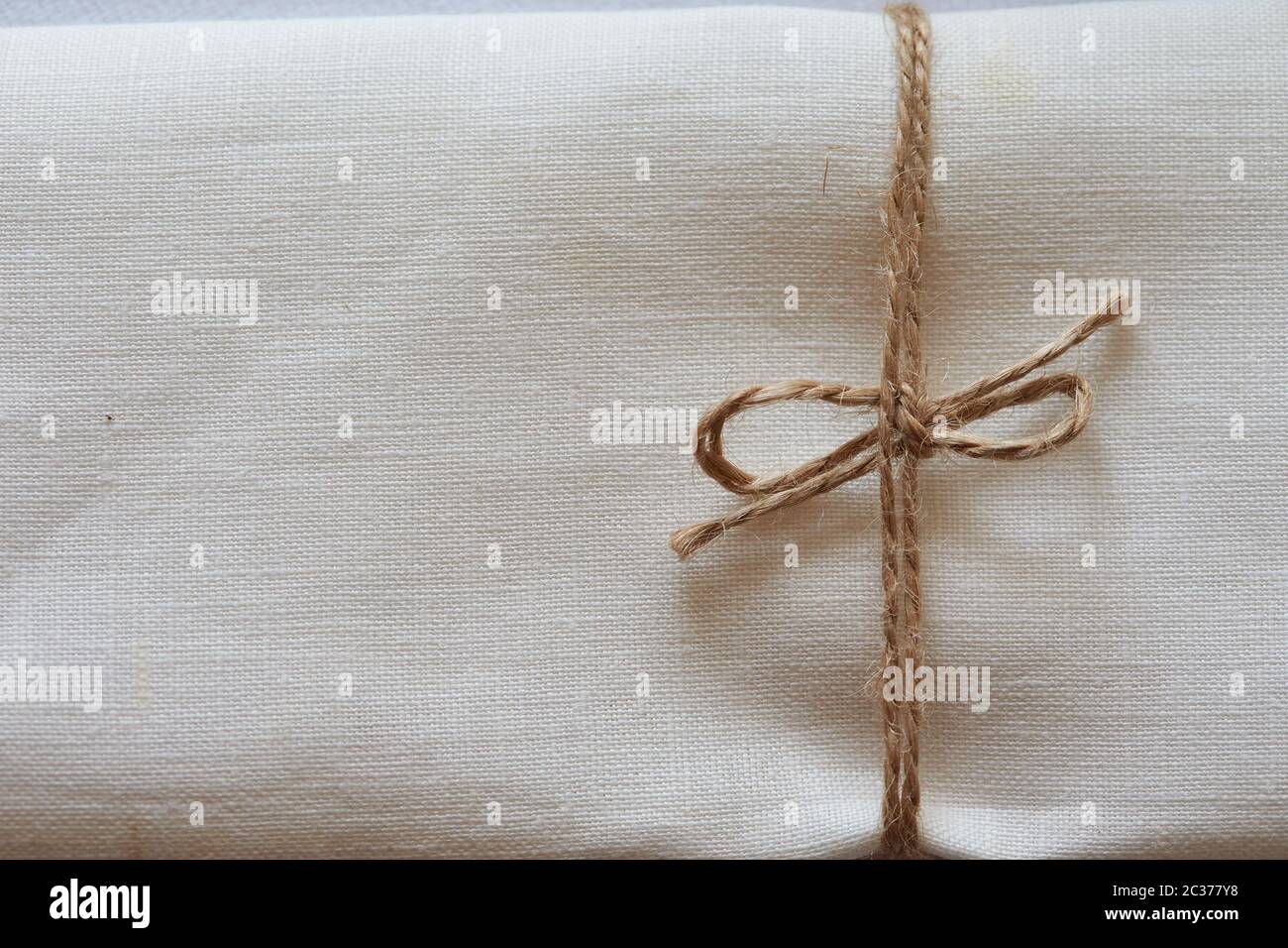 Twine tied in a bow. Close-up. Fabric background Stock Photo - Alamy