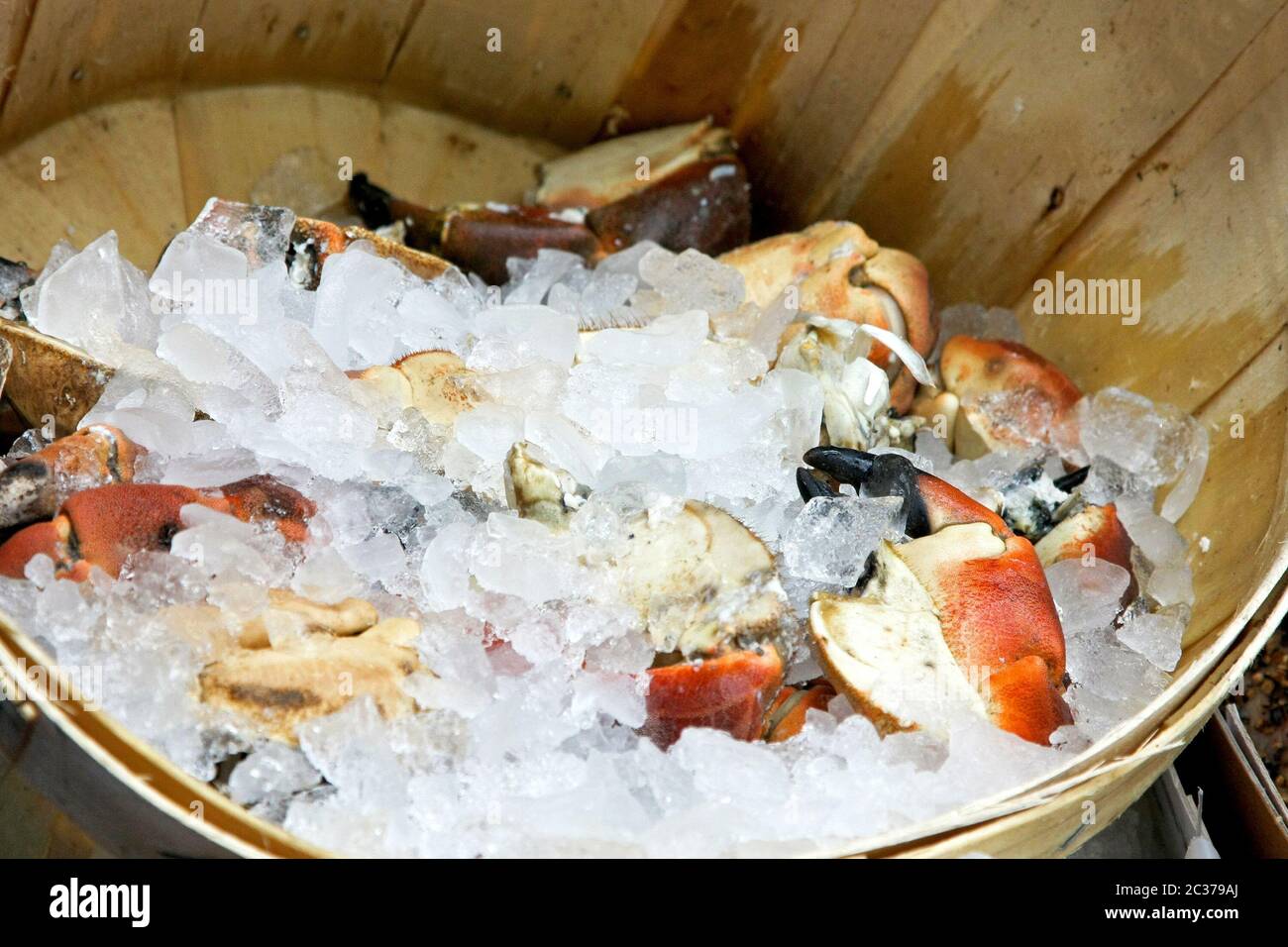 Wooden bucket with lot of frozen crabs Stock Photo - Alamy