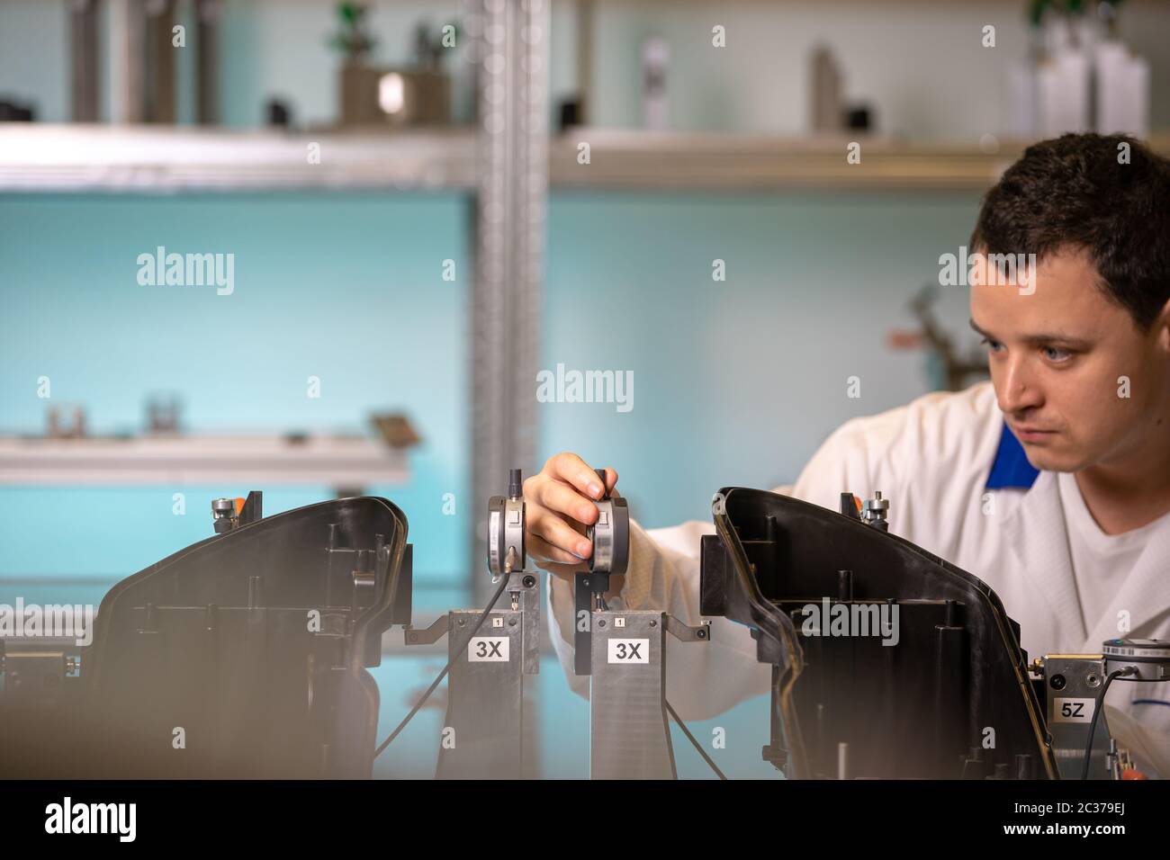 Automotive. Quality Engineer performs measurement of plastic casting ...