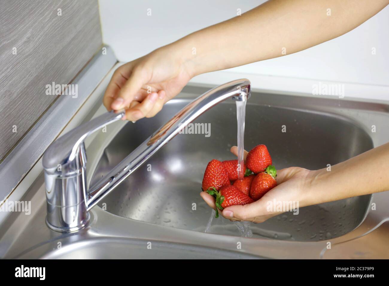 COVID-19 Pandemic Coronavirus Close up woman hands washing fruits to ...