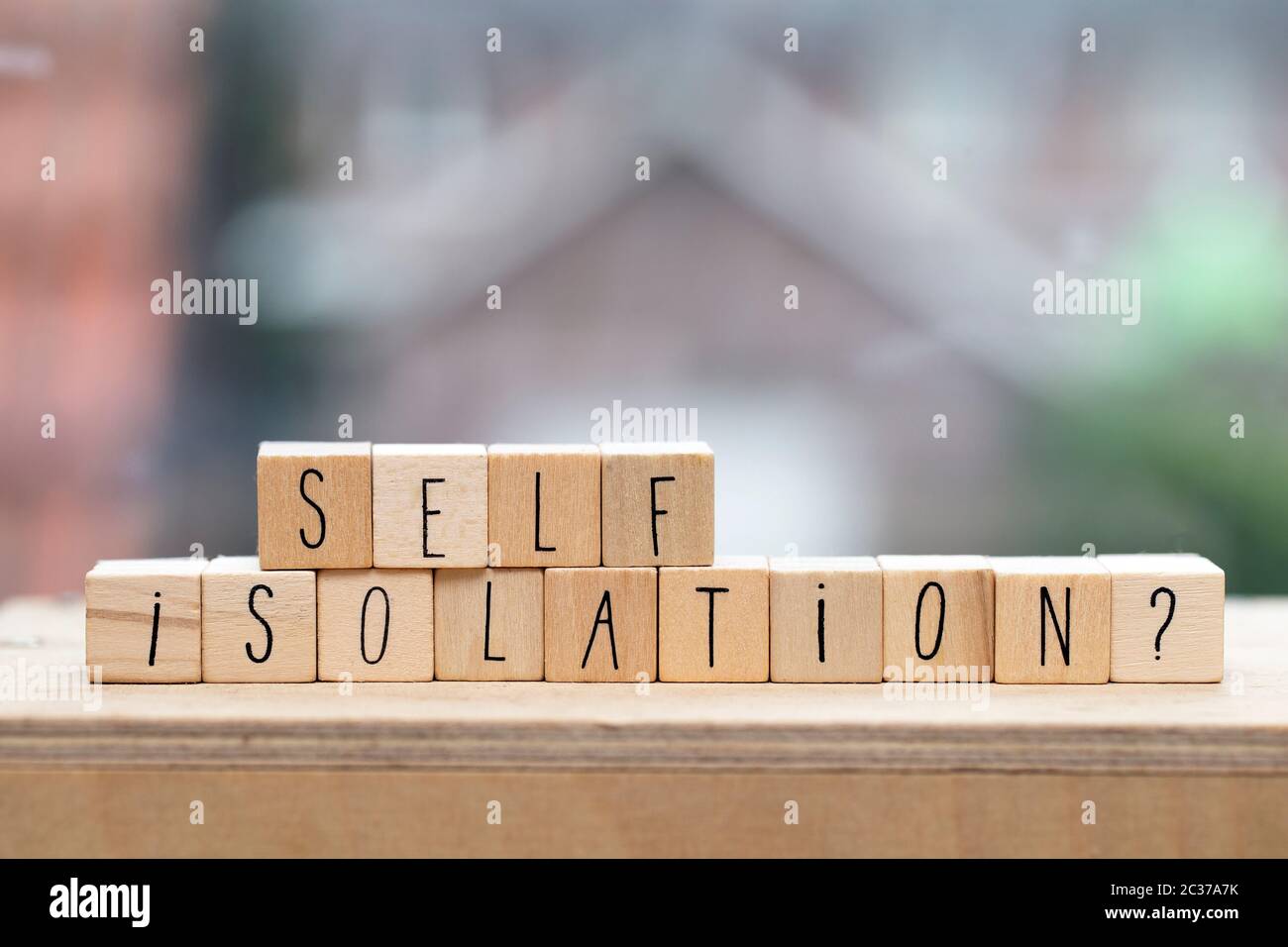 Wooden cubes with the word Self isolation and a question mark for Covid ...