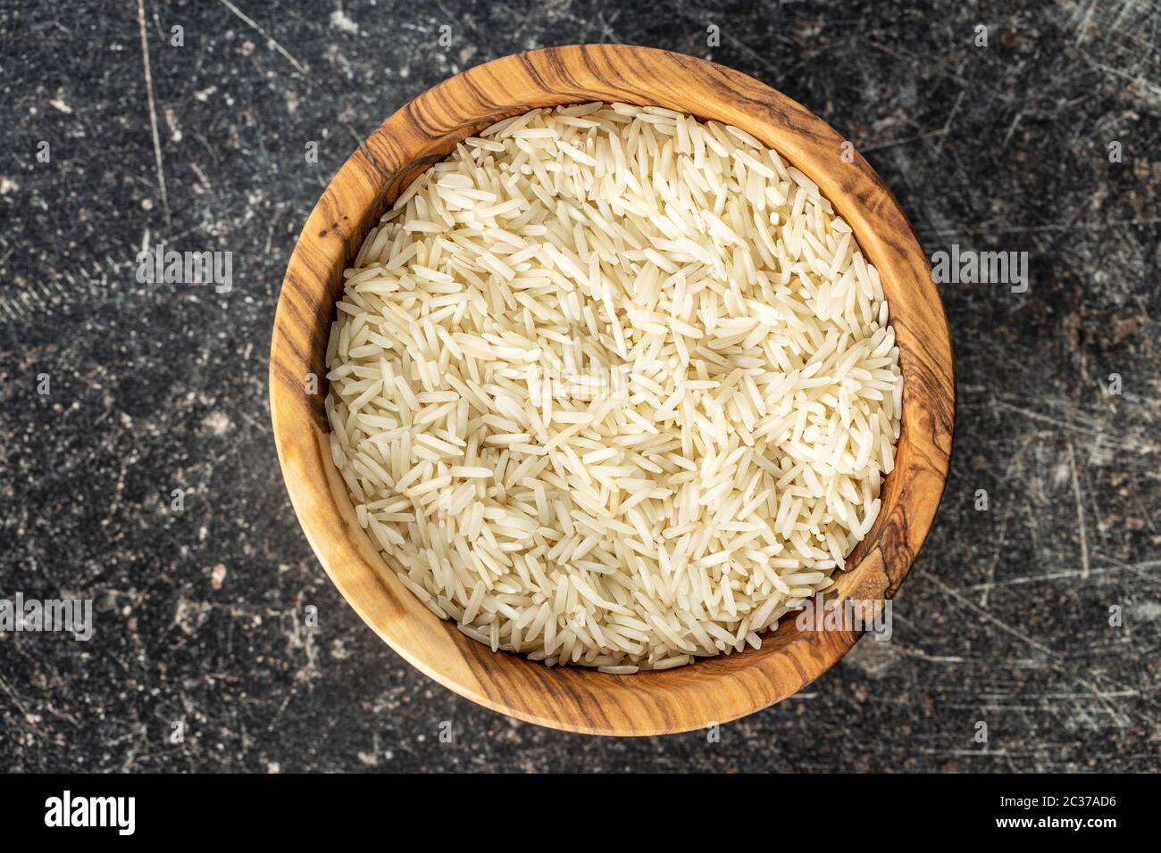 Uncooked indian long rice in bowl. Top view Stock Photo - Alamy