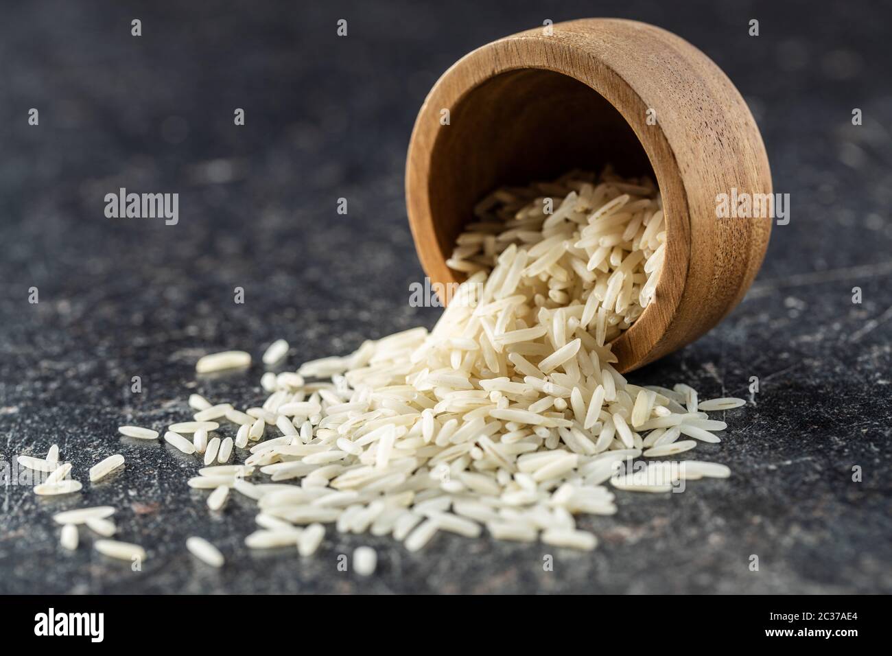Uncooked indian long rice in bowl Stock Photo - Alamy