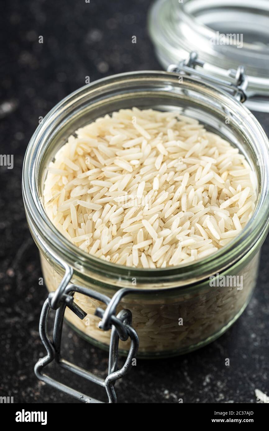 Uncooked indian long rice in jar Stock Photo - Alamy