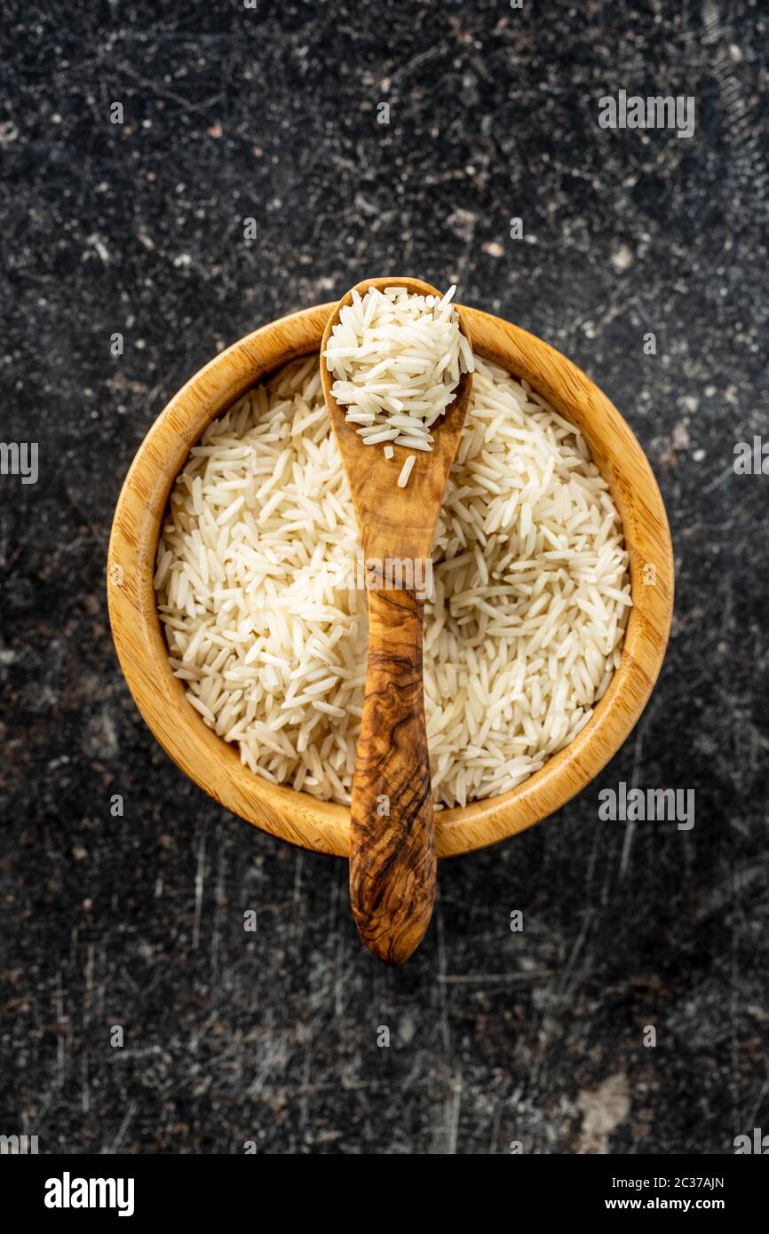 Uncooked indian long rice in bowl. Top view Stock Photo - Alamy