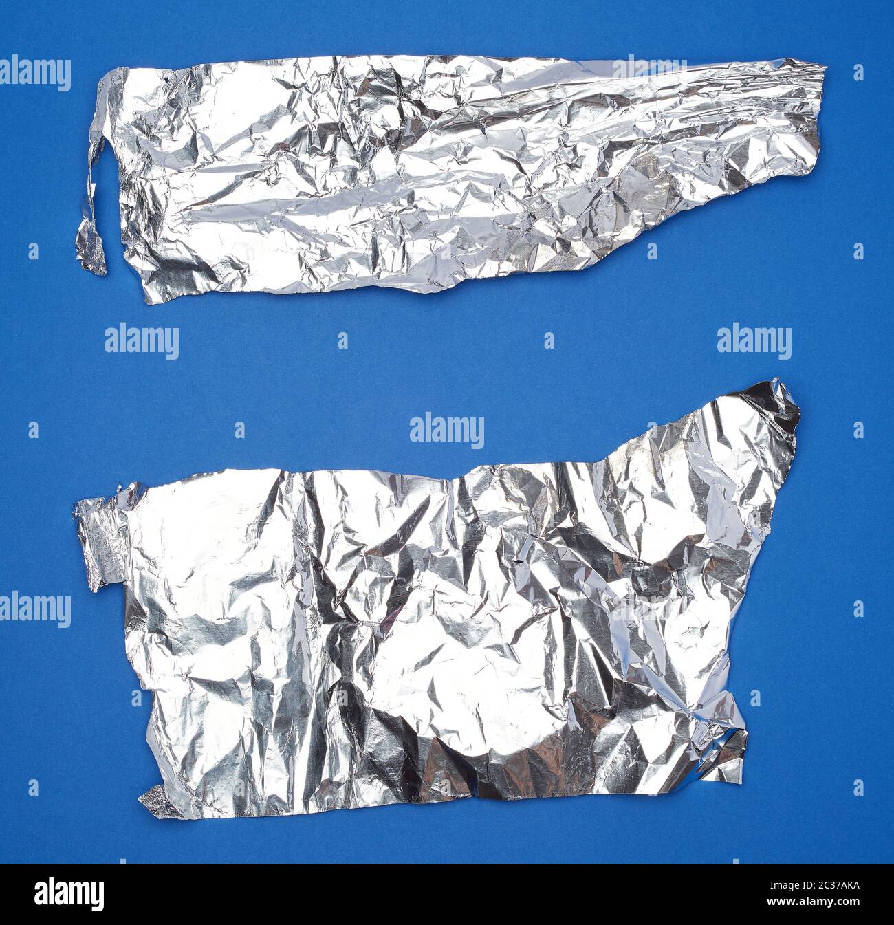 crumpled silver foil sheet, full frame, blue background Stock Photo - Alamy
