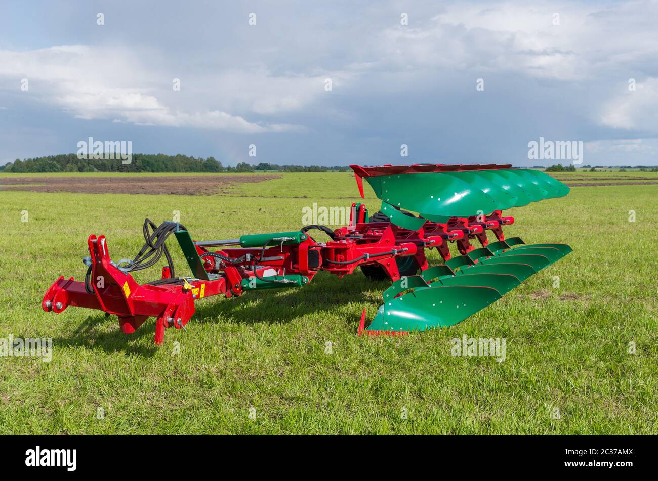 The modern tractor plough placed on the grass Stock Photo - Alamy