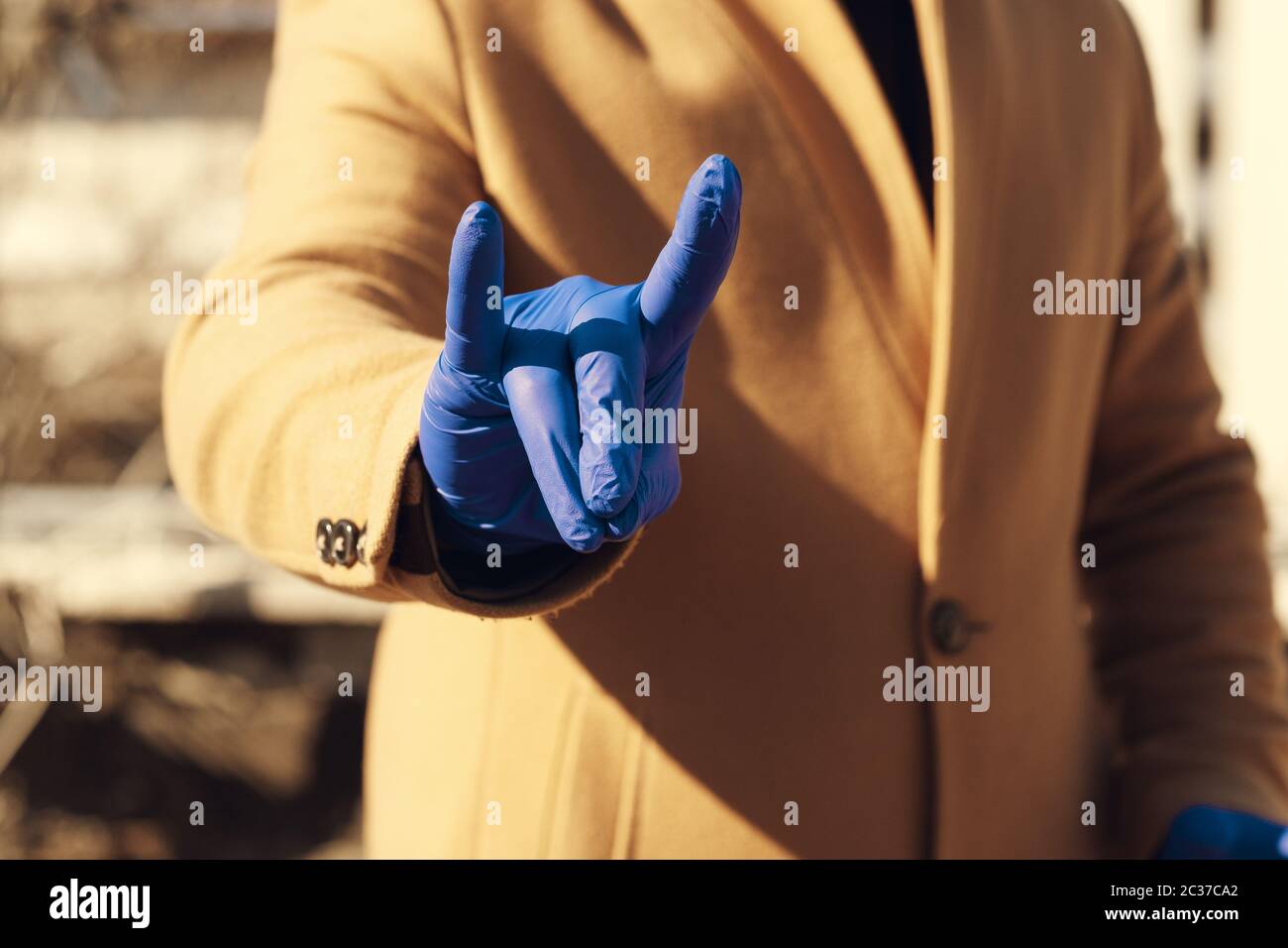 Close up to man hands putting on medical gloves for protection from ...