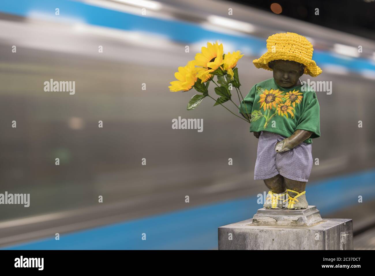 Close-up on a sculpture of a little boy Manneken pee peeing and holding ...