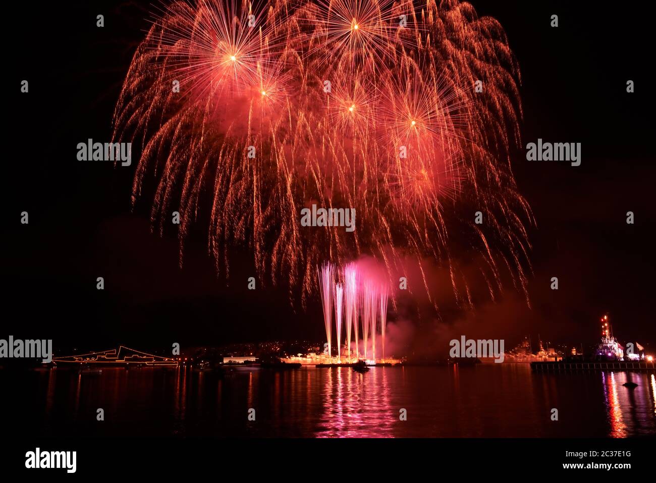 Red colorful fireworks on the black sky background Stock Photo - Alamy