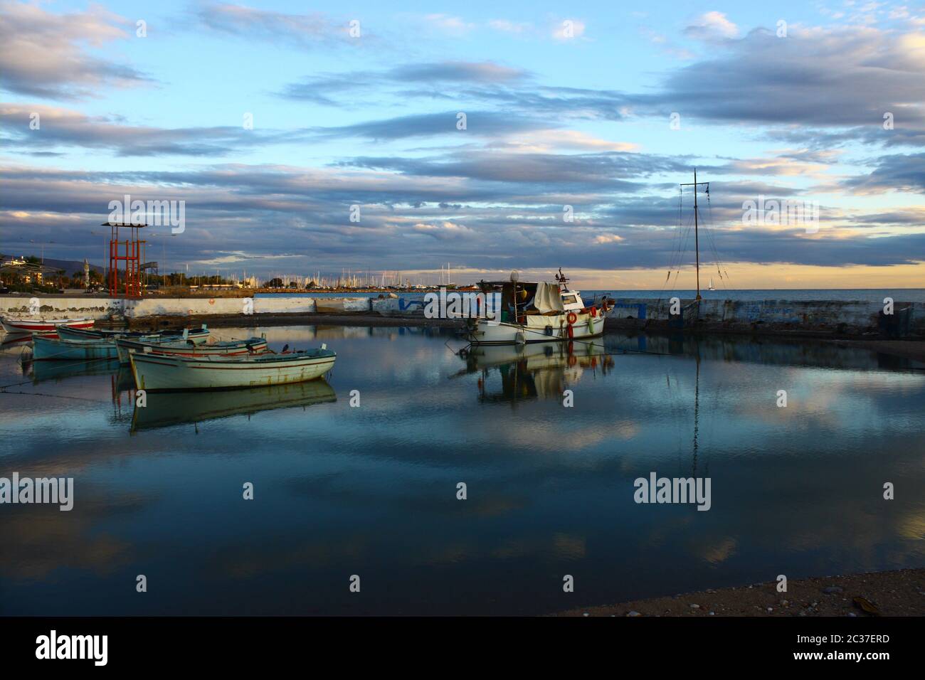 Reflection of boats in a small harbour Stock Photo - Alamy