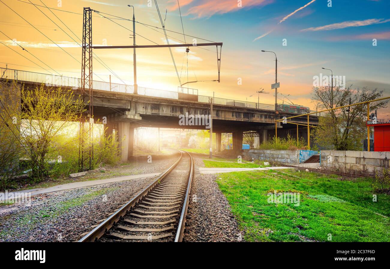 Railway tracks in a rural scene with nice pastel sunset Stock Photo - Alamy