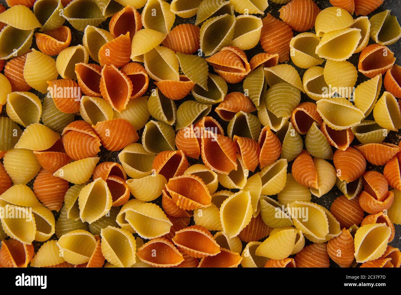 Conchiglie paste of different colors isolated on black background Stock ...