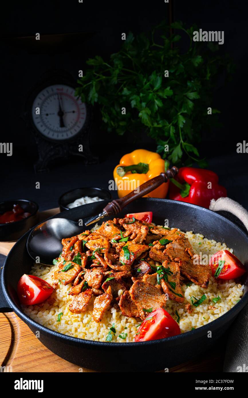 rustic bulgur pans with gratinated gyros and yoghurt Stock Photo - Alamy