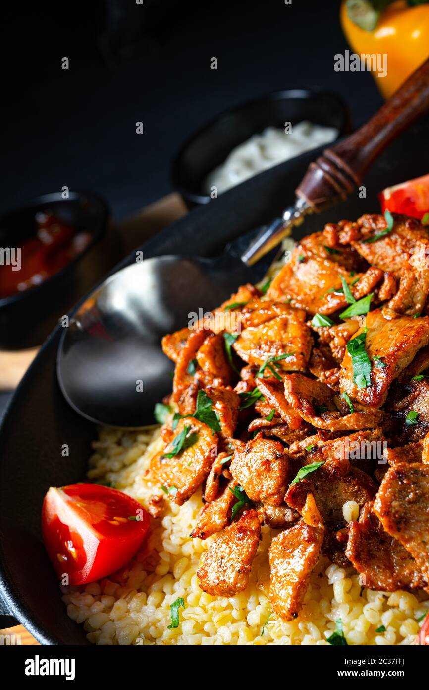rustic bulgur pans with gratinated gyros and yoghurt Stock Photo - Alamy