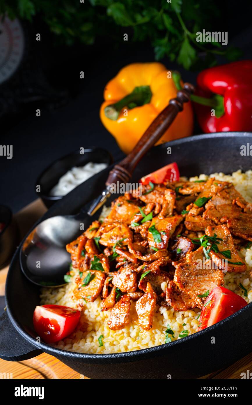 rustic bulgur pans with gratinated gyros and yoghurt Stock Photo - Alamy