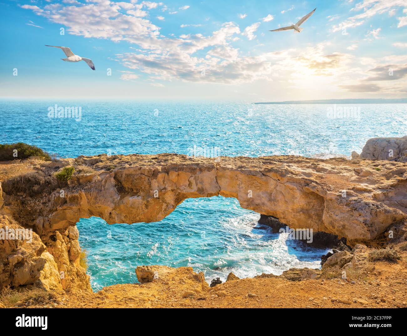Famous Lovers Bridge or Raven Arch with seagulls in the sky. A popular ...