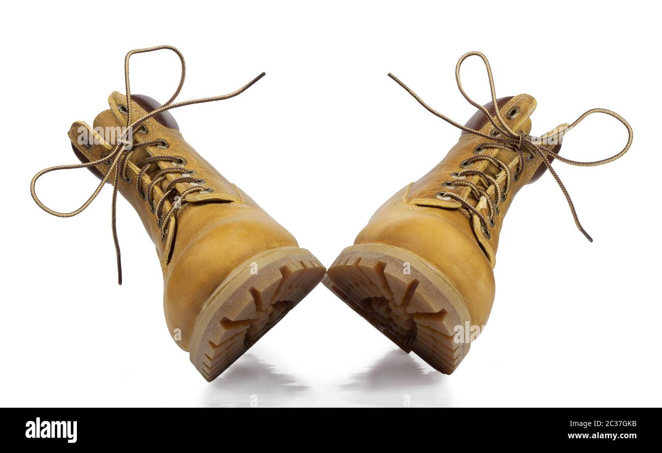 Yellow leather boots standing at an angle isolated on white background ...