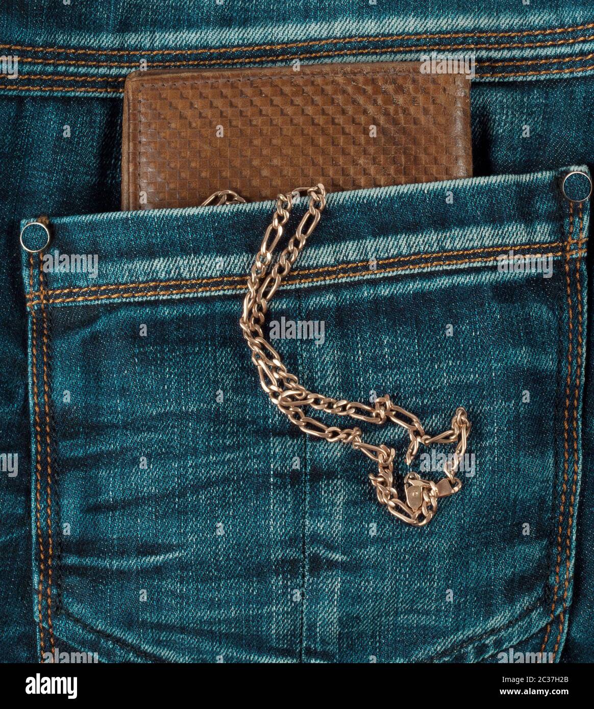 Pocket jeans with a wallet and a gold chain Stock Photo - Alamy