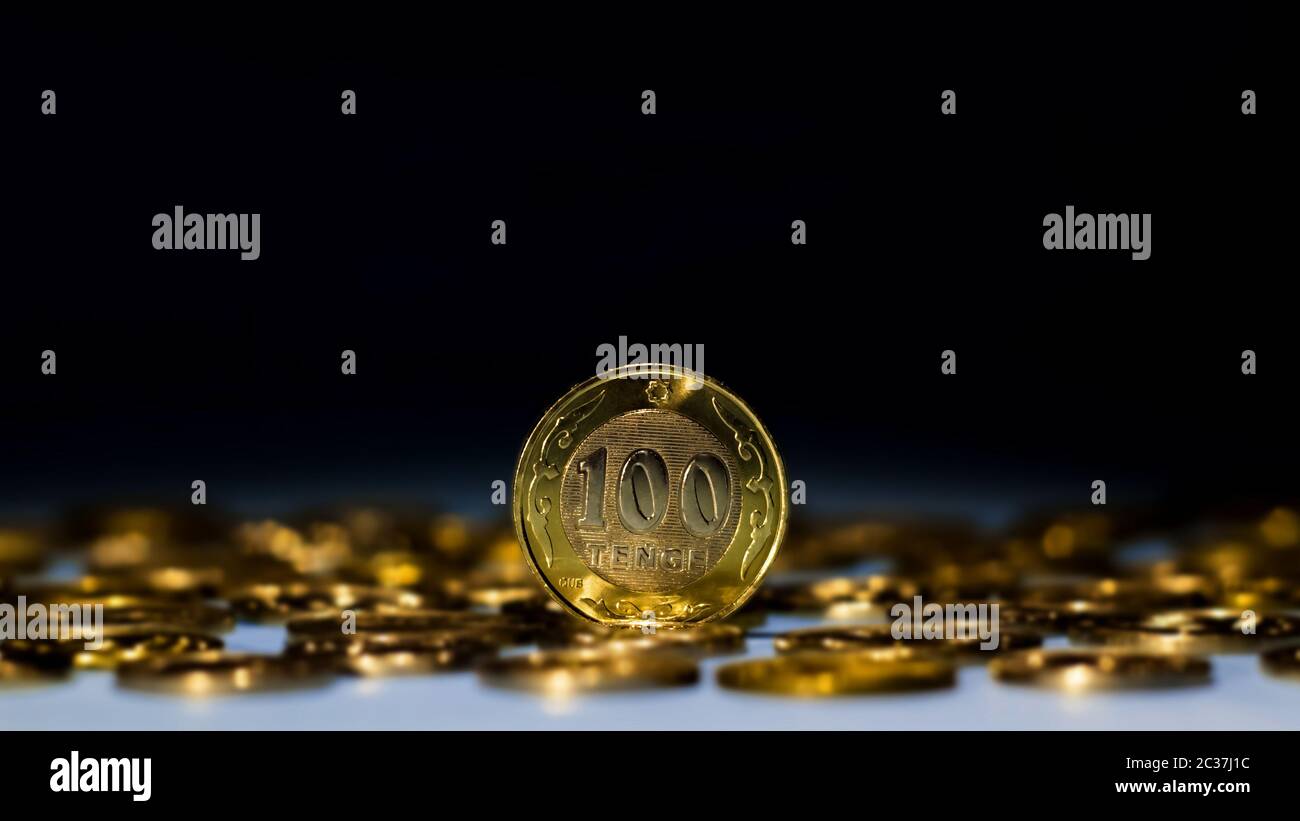 Tenge on a blue background with coins. Tenge coins of Kazakhstan Stock ...