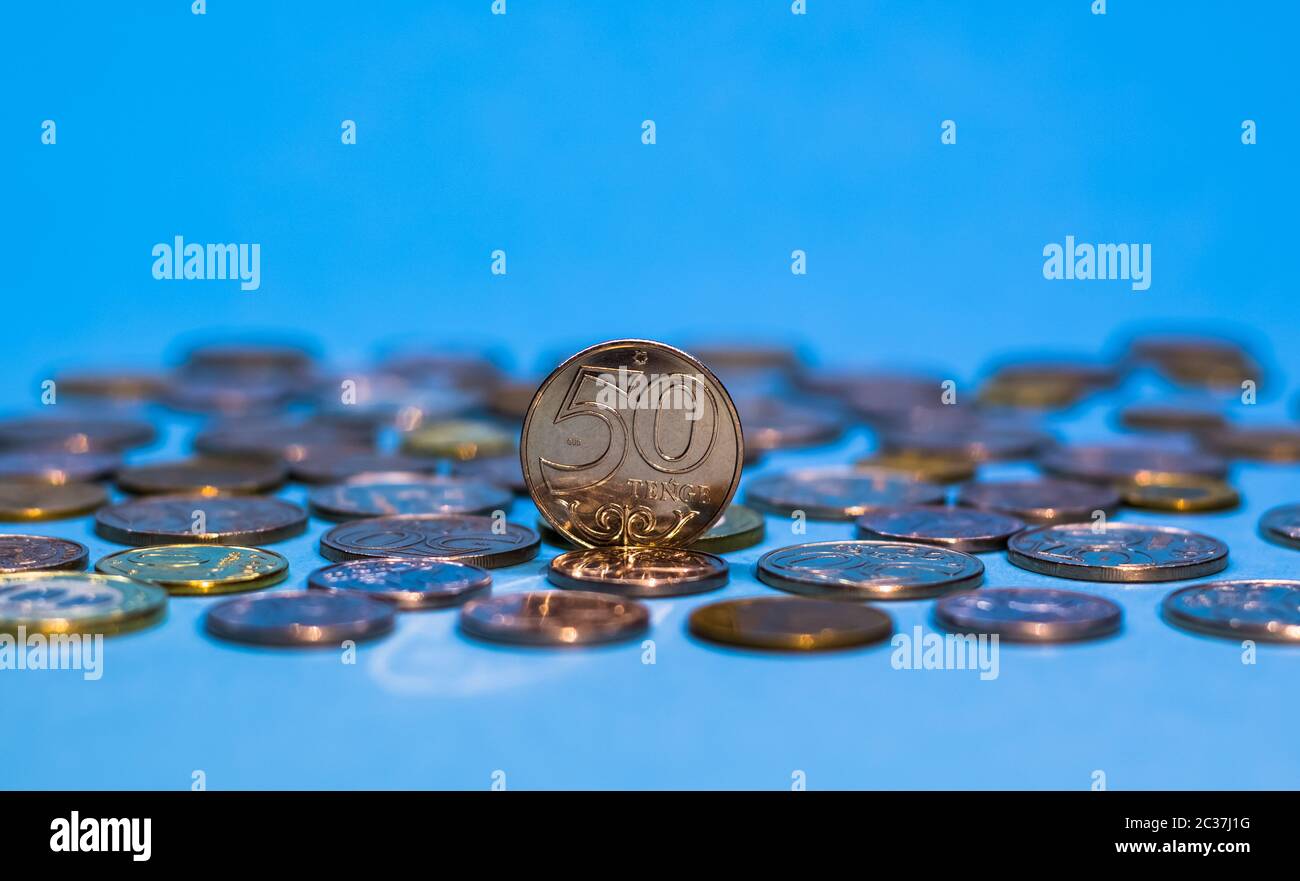 Tenge on a blue background with coins. Tenge coins of Kazakhstan Stock ...