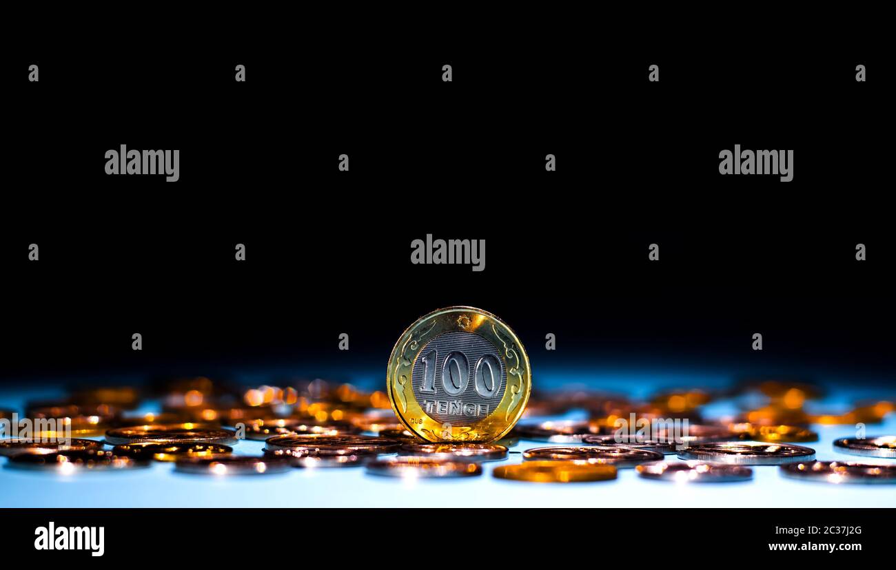 Tenge on a blue background with coins. Tenge coins of Kazakhstan Stock ...