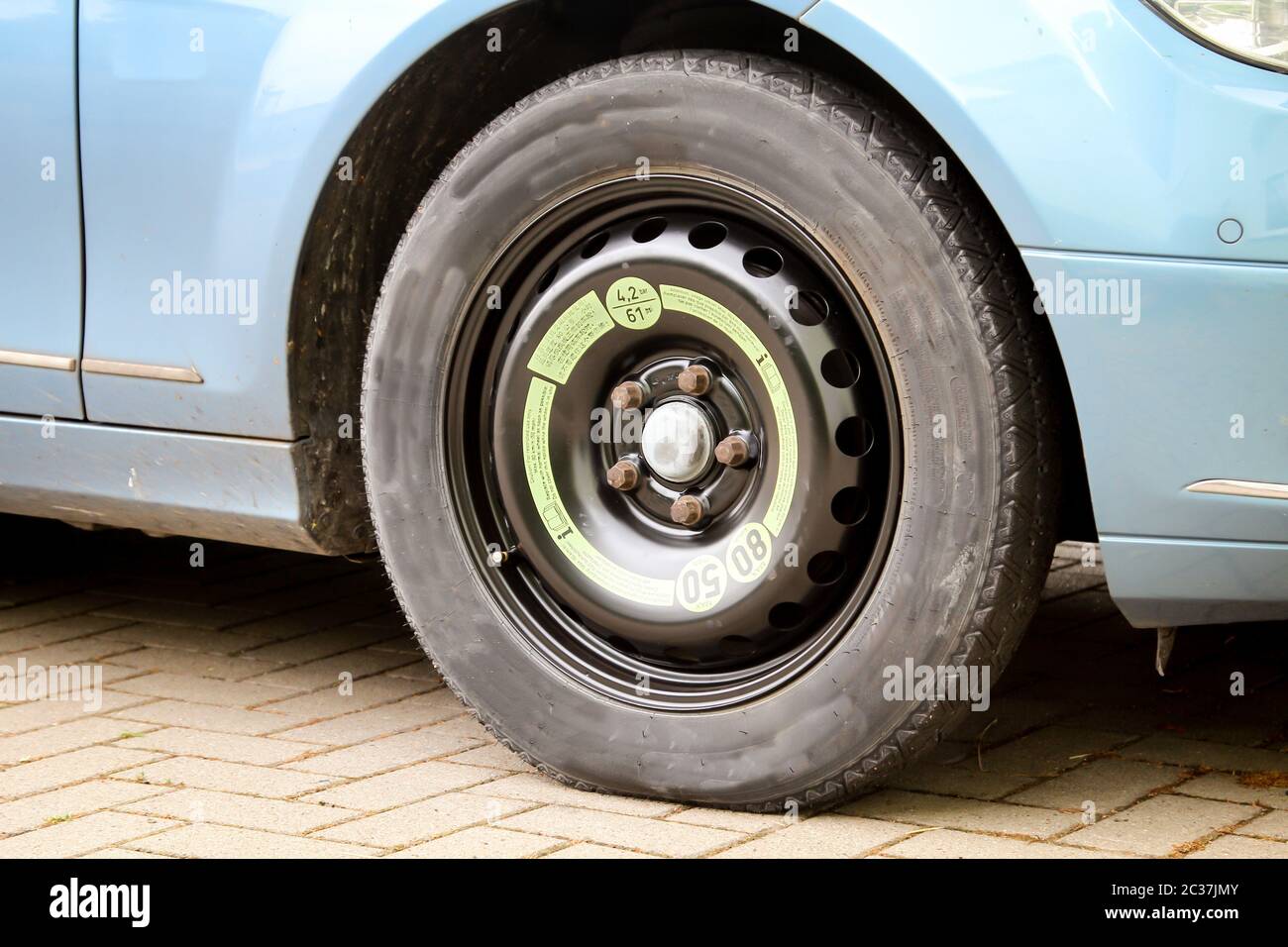 An emergency wheel was mounted on a car after a puncture Stock Photo ...