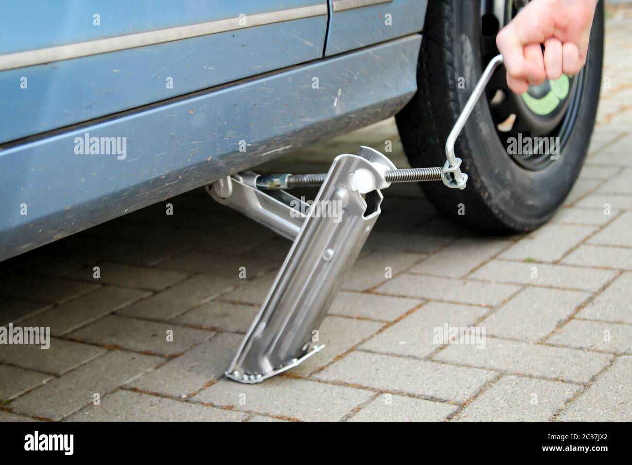 An emergency wheel was mounted on a car after a puncture Stock Photo ...