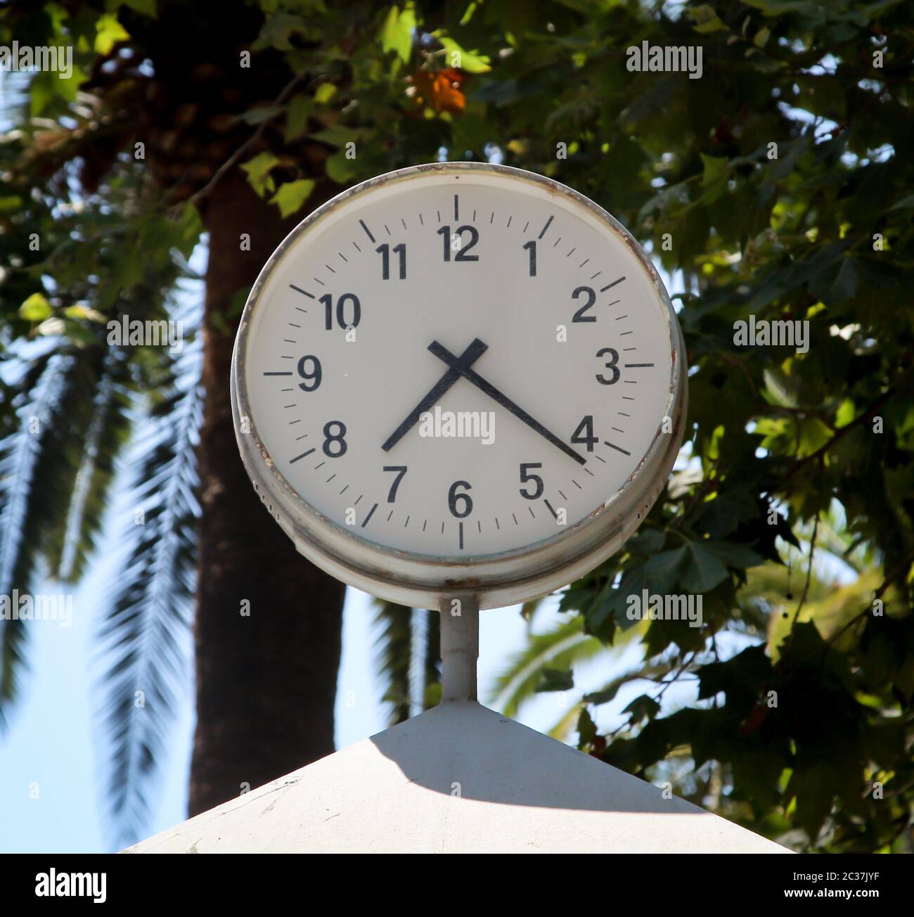 a big clock shows people the time in a public square Stock Photo - Alamy