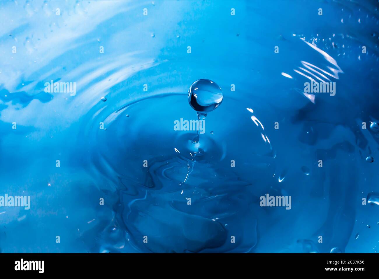 Drop of water. Blue water drop. Falling water. Water splash close-up ...