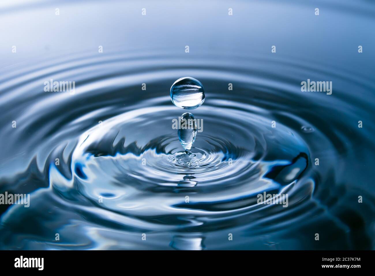 Splash of water close-up. Water drop. A blue drop of water. Falling ...