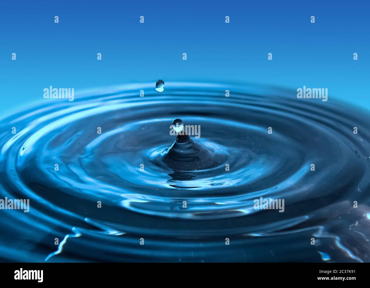 Drop of water. Blue water drop. Falling water. Water splash close-up ...